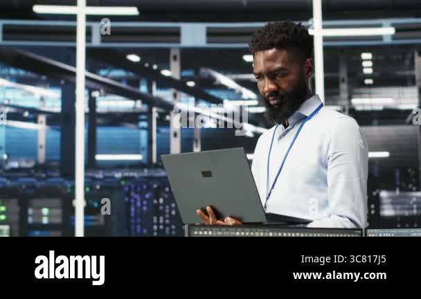 Portrait of cheerful data center engineer analyzing gear issues using node tree tools. Upbeat ...