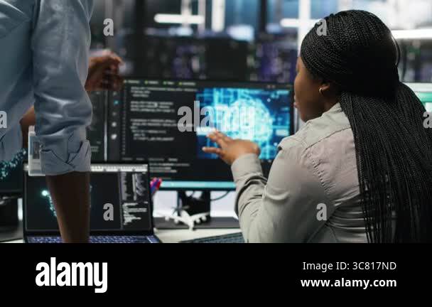 Data center manager supervising worker deploying AI solutions optimizing equipment. Server farm ...