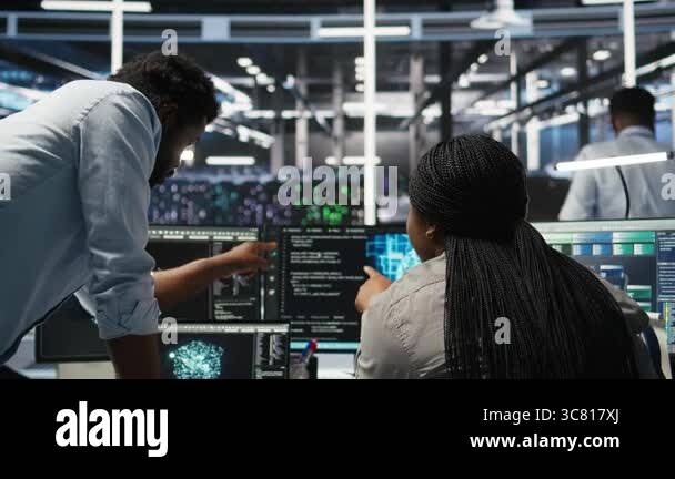 Data center manager supervising worker deploying AI solutions ...