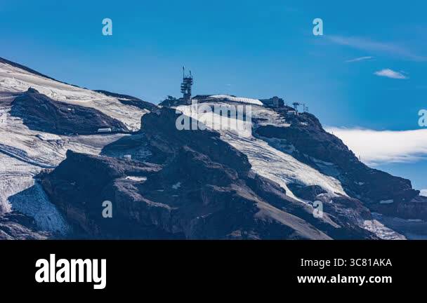 Time lapse, view on Titlis cable car station. Mountain covered with ...