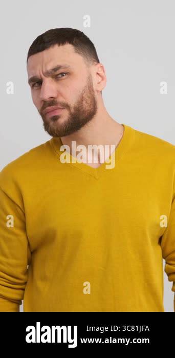 Portrait of a perplexed and astonished man in doubt looking at the ...
