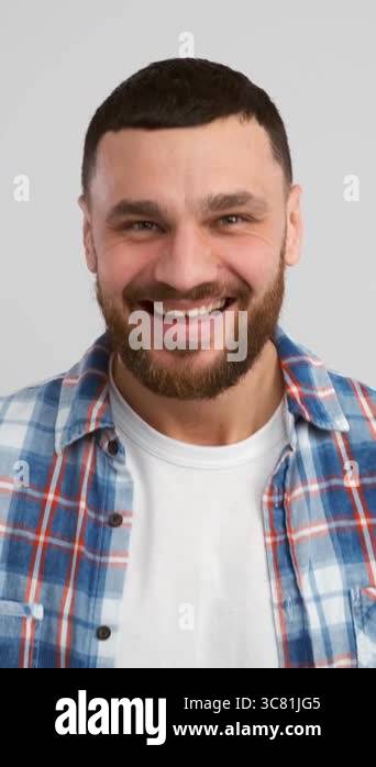 Man laughing with a playful and cheerful expression on a white ...