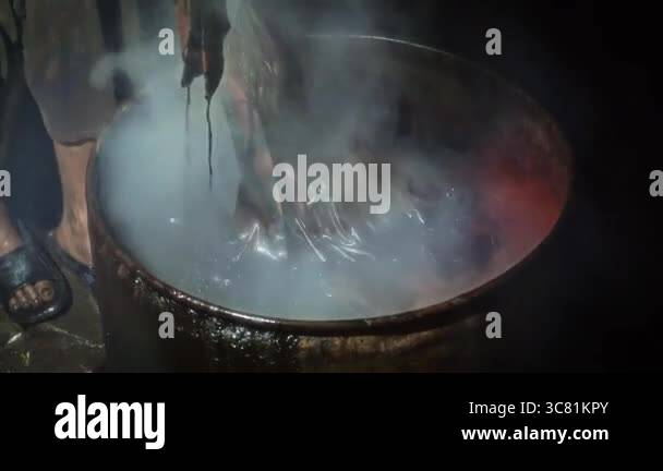 Boiling batik with hot water and soda ash to clean the wax. The ...