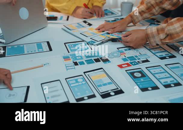 A dynamic design workshop showcasing teamwork as professionals engage in creating mobile ...