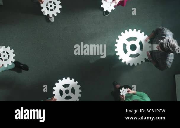 Top down aerial view of business team working together to gather cog ...