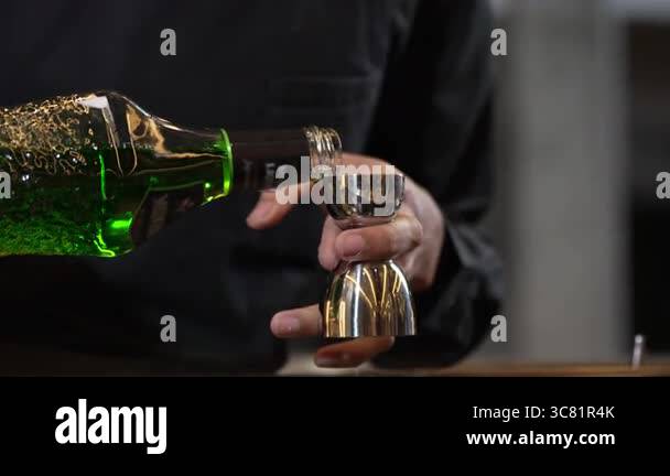 Closeup mixing hand bartender holding jigger to measure liquor sugar ...