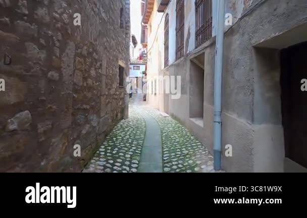 Narrow alley with old stone houses in the medieval village of ...