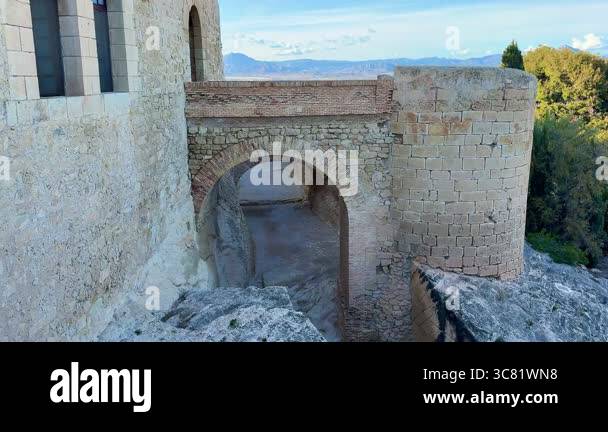 A stunning view features a historic stone bridge connecting majestic ...