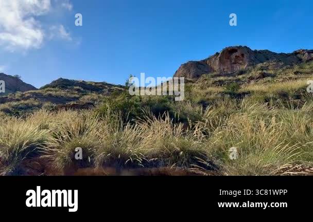 A breathtaking and picturesque landscape showcases gentle grassy slopes ...