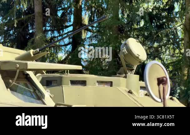 A closeup view of a military armored vehicle shows its turret and ...