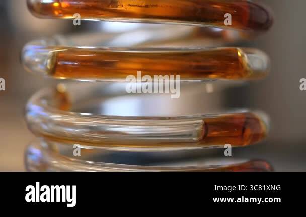 Close-Up of Amber Liquid in a Glass Helix Laboratory Apparatus Stock ...