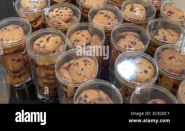 Transparent plastic containers with cookies in the shape of nuts filled ...