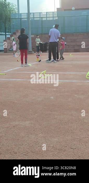 Delhi, India, April 16, 2025 - Junior tennis players having coaching ...