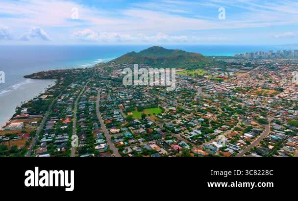 Aerial shot shows residential area along a beautiful Kahala beach ...