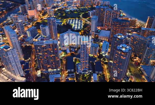 Aerial view of Honolulu cityscape at night with Waikiki Beach and ocean ...