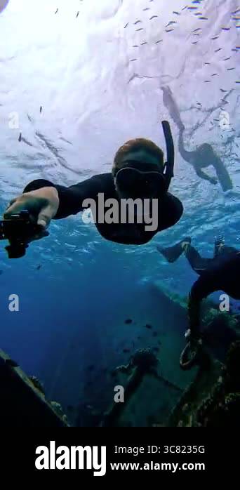 Freedivers explore the Vaavu Shipwreck underwater near Keyodhoo Island ...