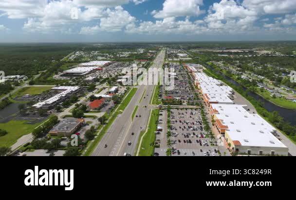 Wide highway with shopping malls and small businesses in North Port ...