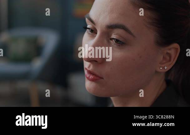 Close up shot of young Caucasian depressive woman crying and drinking ...