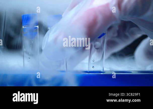 Testing sample of liquid in test tube close up zoom shot slow motion ...
