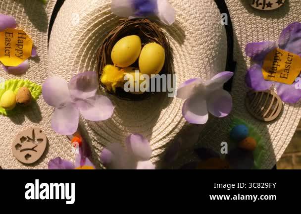 Easter bonnet straw hat decorated with eggs and flowers close up zoom ...