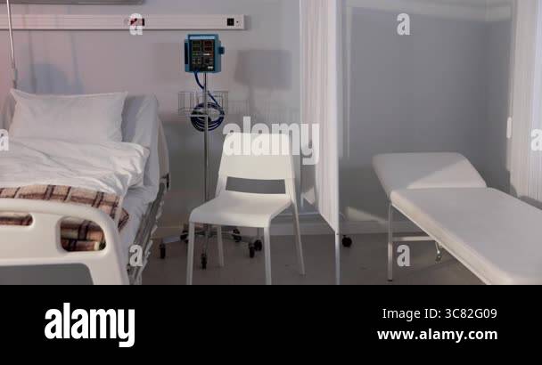 A clean and wellequipped hospital room that includes a comfortable bed ...