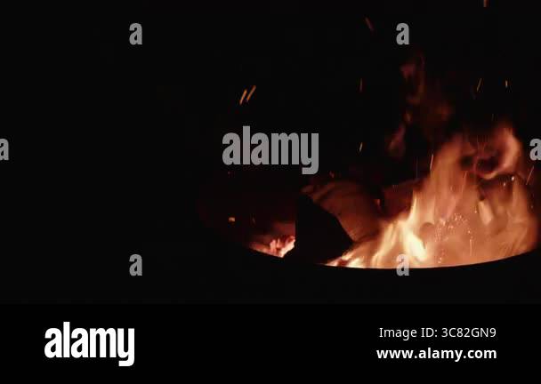A flamethrower blasts intense flames onto the wood in the fire pit ...