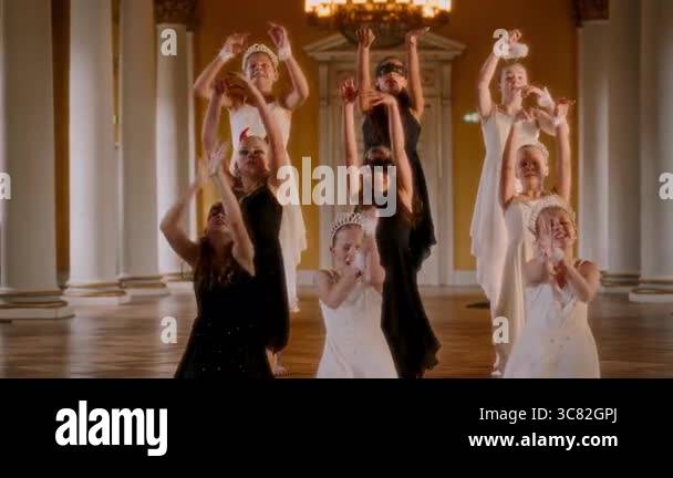A dramatic dance performance featuring young dancers in dark ...