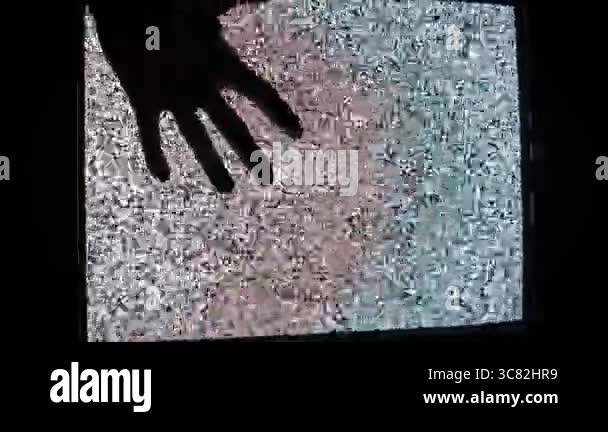 Close-up dark silhouette hand reaching out and gently touching the ...