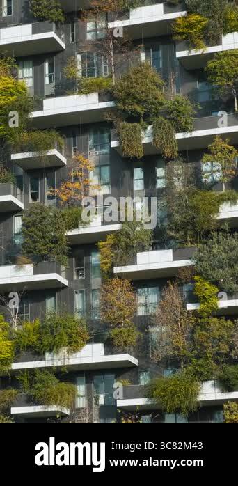 Vertical forest building with lush greenery and trees integrated into ...