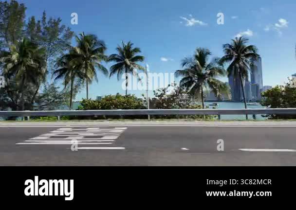 View of downtown Miami skyline and emerald green bay from Tesla Y car ...
