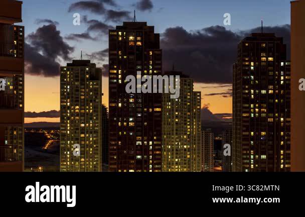 Sunset footage between the city and buildings. Dance of clouds above ...