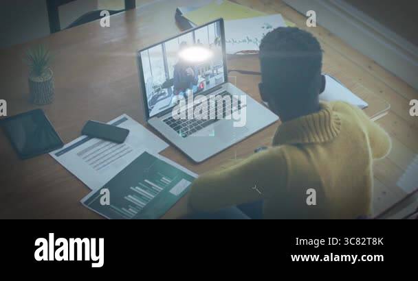 QR code scanning animation over person working at desk with laptop ...