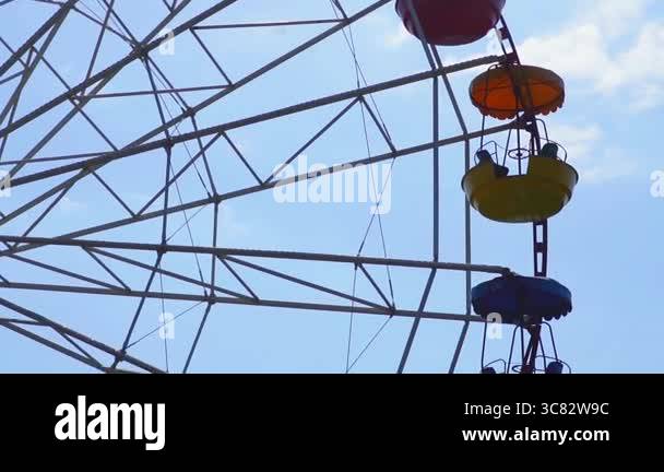 Close shot of weathered ferris wheel structure in forgotten theme park ...