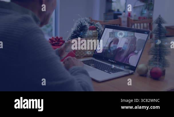 Video chatting with family on laptop, person surrounded by holiday ...