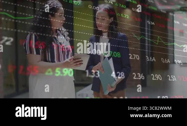 Two women discussing over stock market data animation in office setting ...
