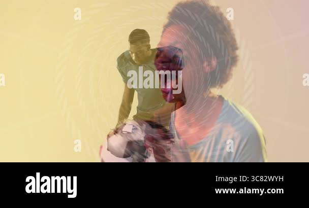 Football player in helmet running over cheering fan with face paint ...