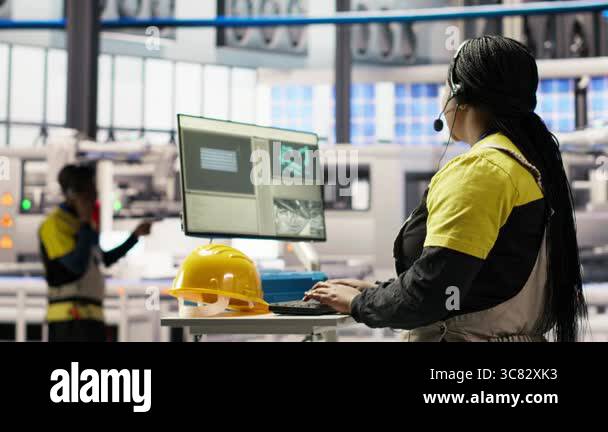 Technician remotely supervising smart factory production lines ...