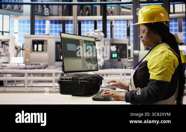 Woman in smart factory expert uses computer to implement automated ...