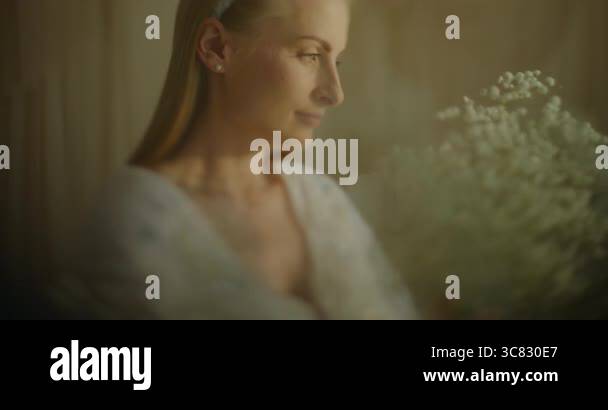 A contemplative woman gazes out the window, reflecting with nostalgia ...