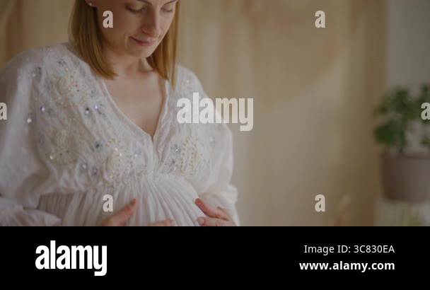 Portrait of a smiling young mother eagerly awaiting her first son ...