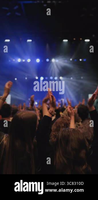 Clapping female hands in the foreground along with a clapping crowd of ...