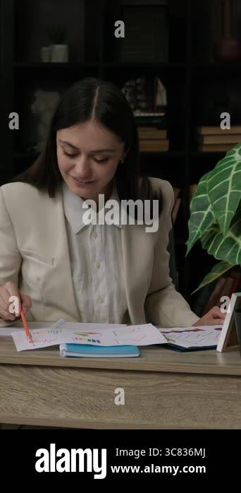 Happy female lawyer smiling and analyzing several financial documents ...
