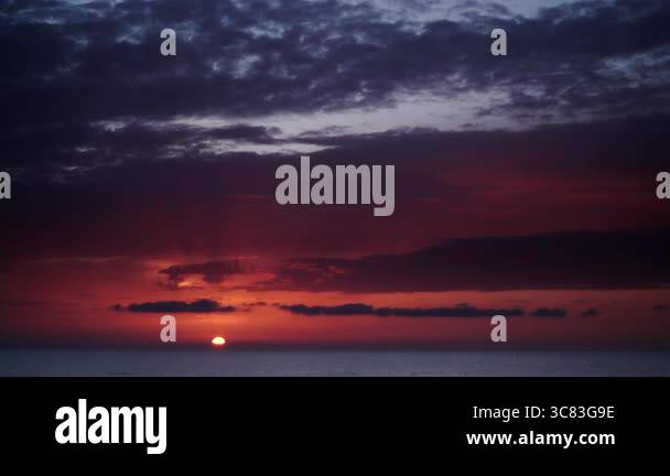 Seascape at early morning. Time lapse of dark stormy clouds moving over ...