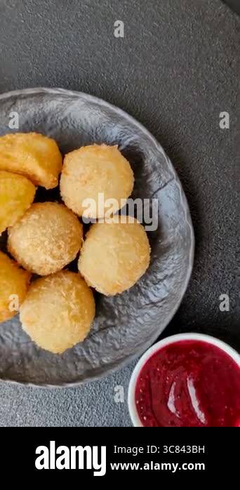 Fried mozzarella or brie cheese with cranberry or raspberry sauce. Fast ...