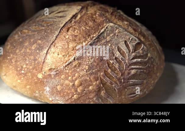 A close-up view of crusty sourdough bread showcasing its golden ...