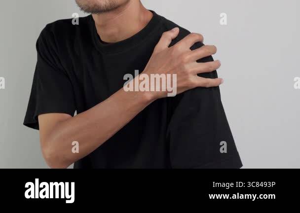Man experiencing arm pain, holding and massaging her sore arm with ...