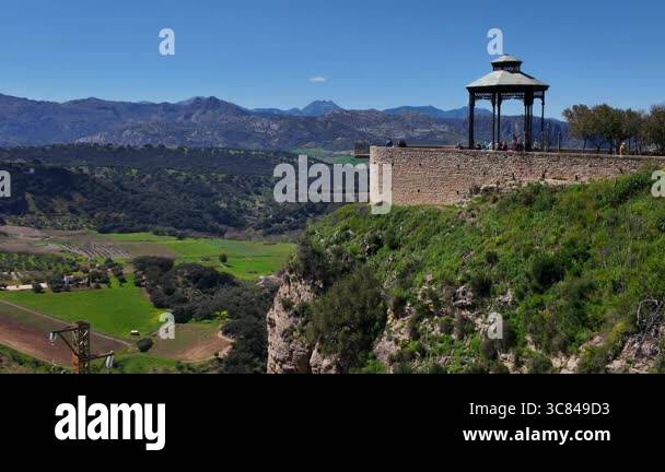 Tourists admiring stunning valley landscape from Ronda viewpoint in ...