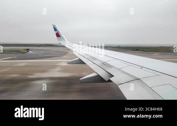 American Airlines plane taking off from JFK airport on cloudy day with ...