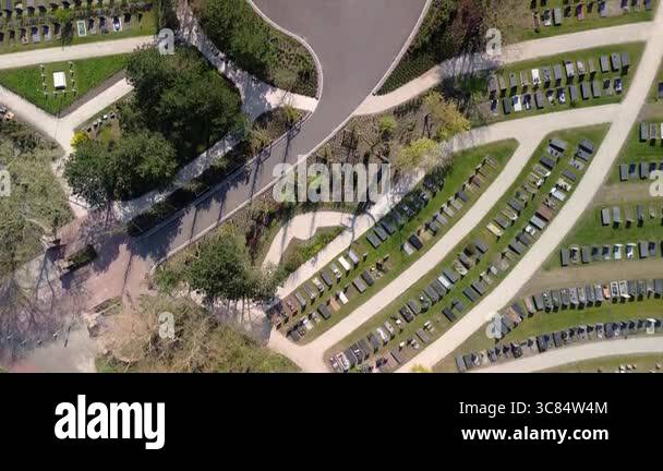 Aerial view of a cemetery with symmetrical rows of graves, a central ...