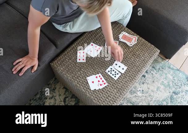This video shows a woman laying out playing cards on a table in a ...